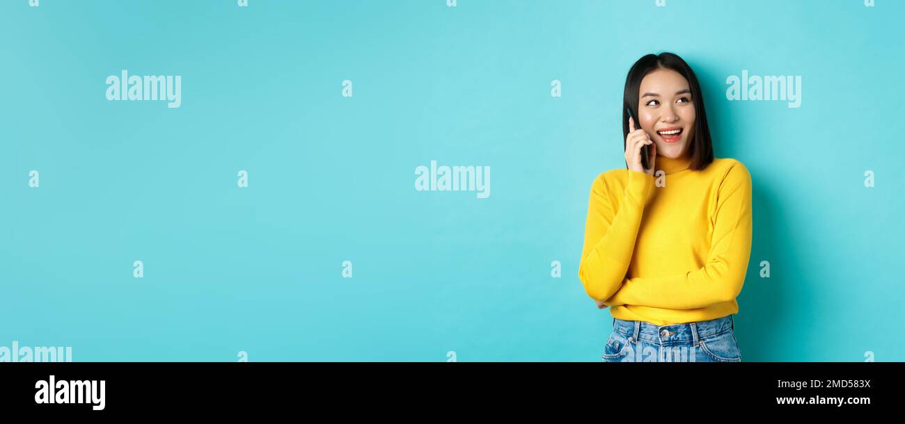 Stylish korean woman calling on phone, talking on smartphone and ...
