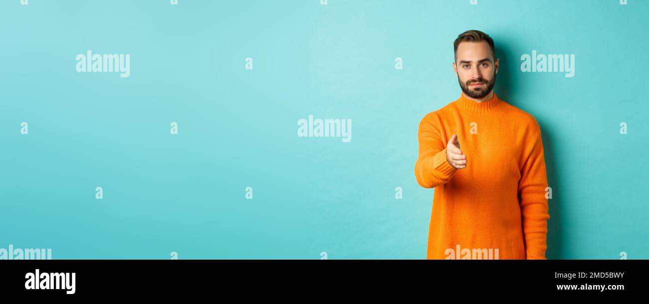 Confident man extending hand for handshake, greeting you, looking self ...