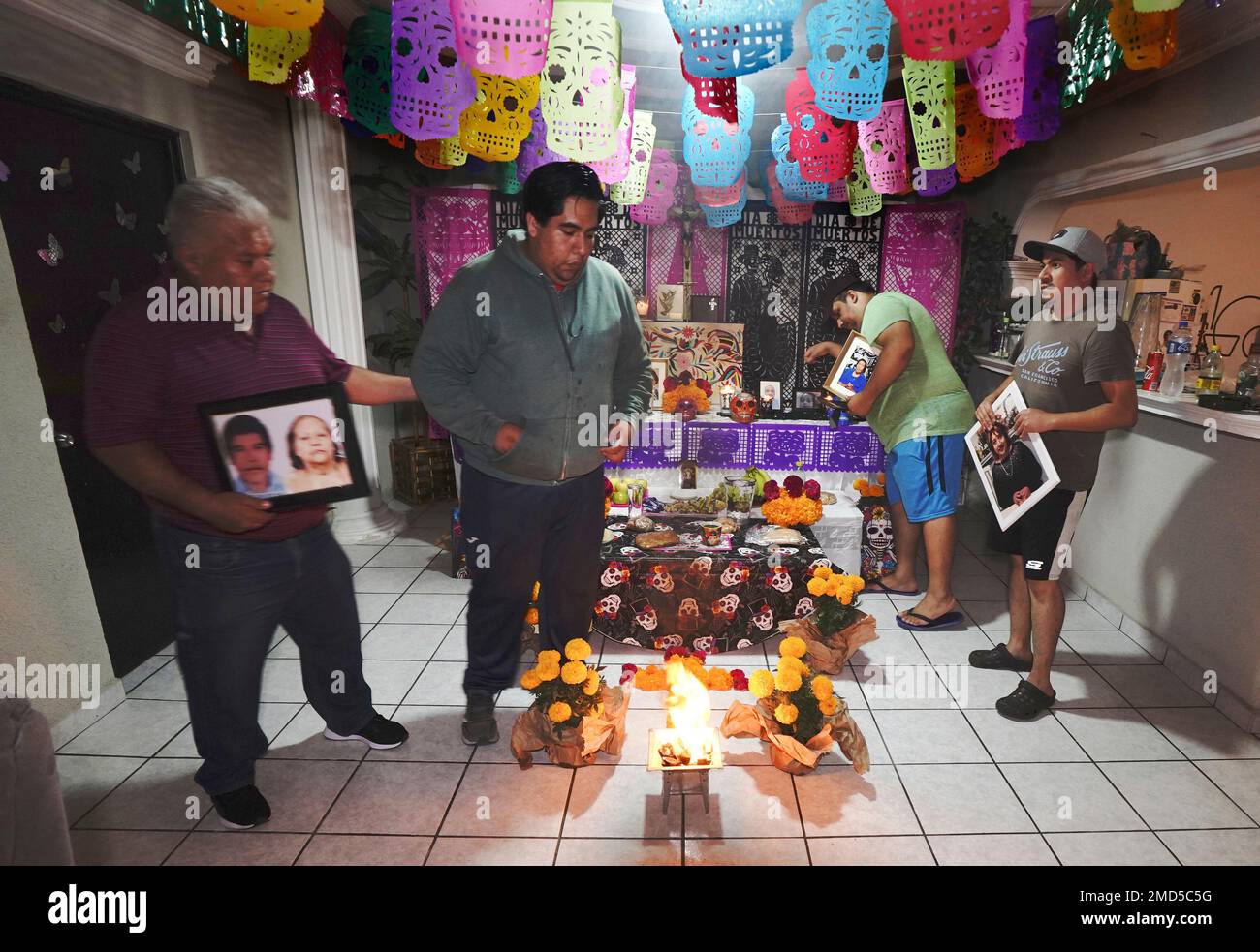 The Cervantes family prepares a Day of the Dead altar in remembrance of ...