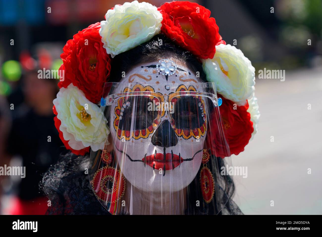 A woman made up as a "Catrina" and wearing a face shield posed for a ...