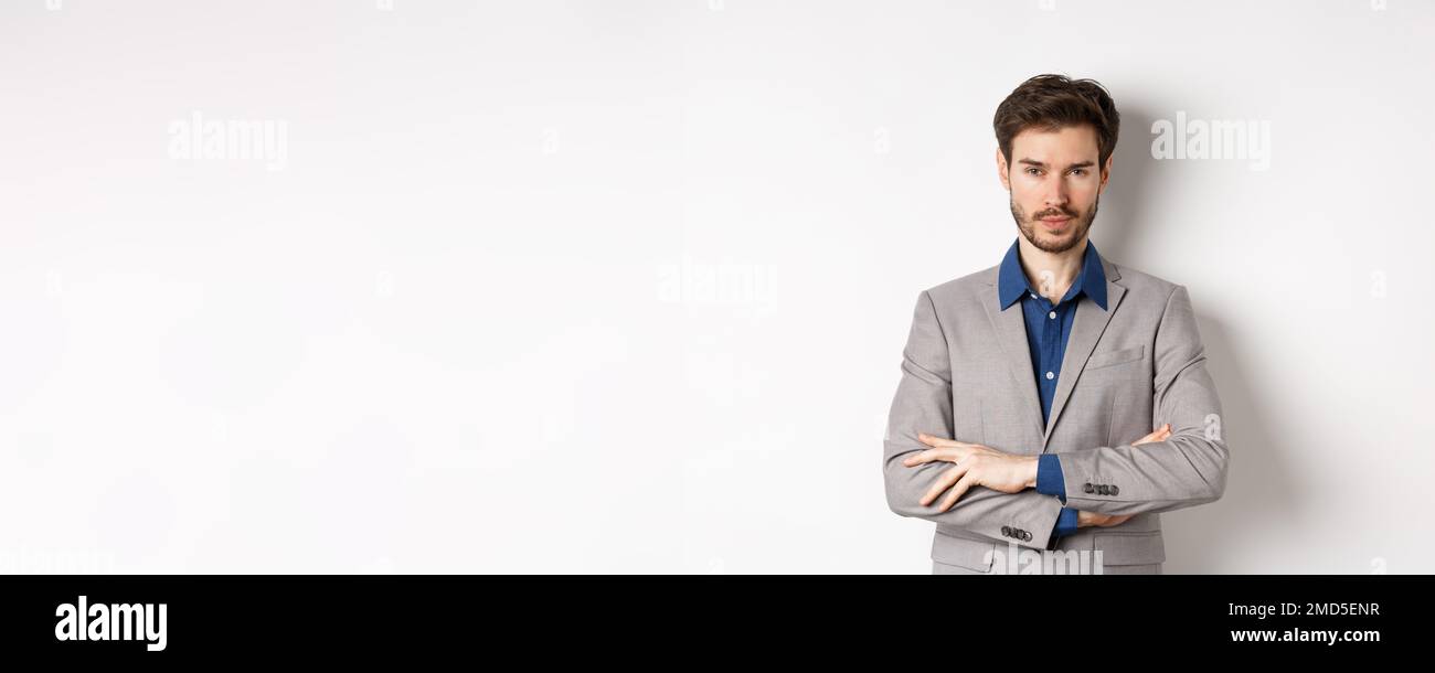 Confident young man looking like professional, cross arms on chest in ...