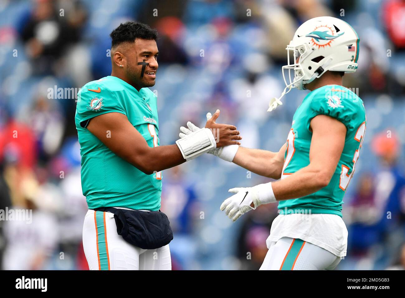 Miami Dolphins quarterback Tua Tagovailoa (1) with running back Patrick ...