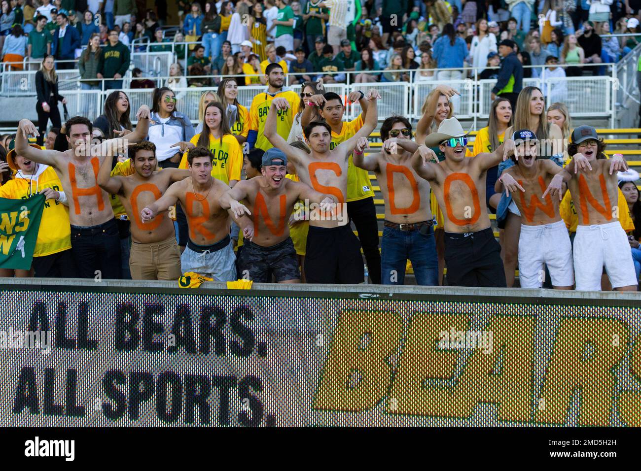 Spectators flash the horns down hand sign before an NCAA college ...