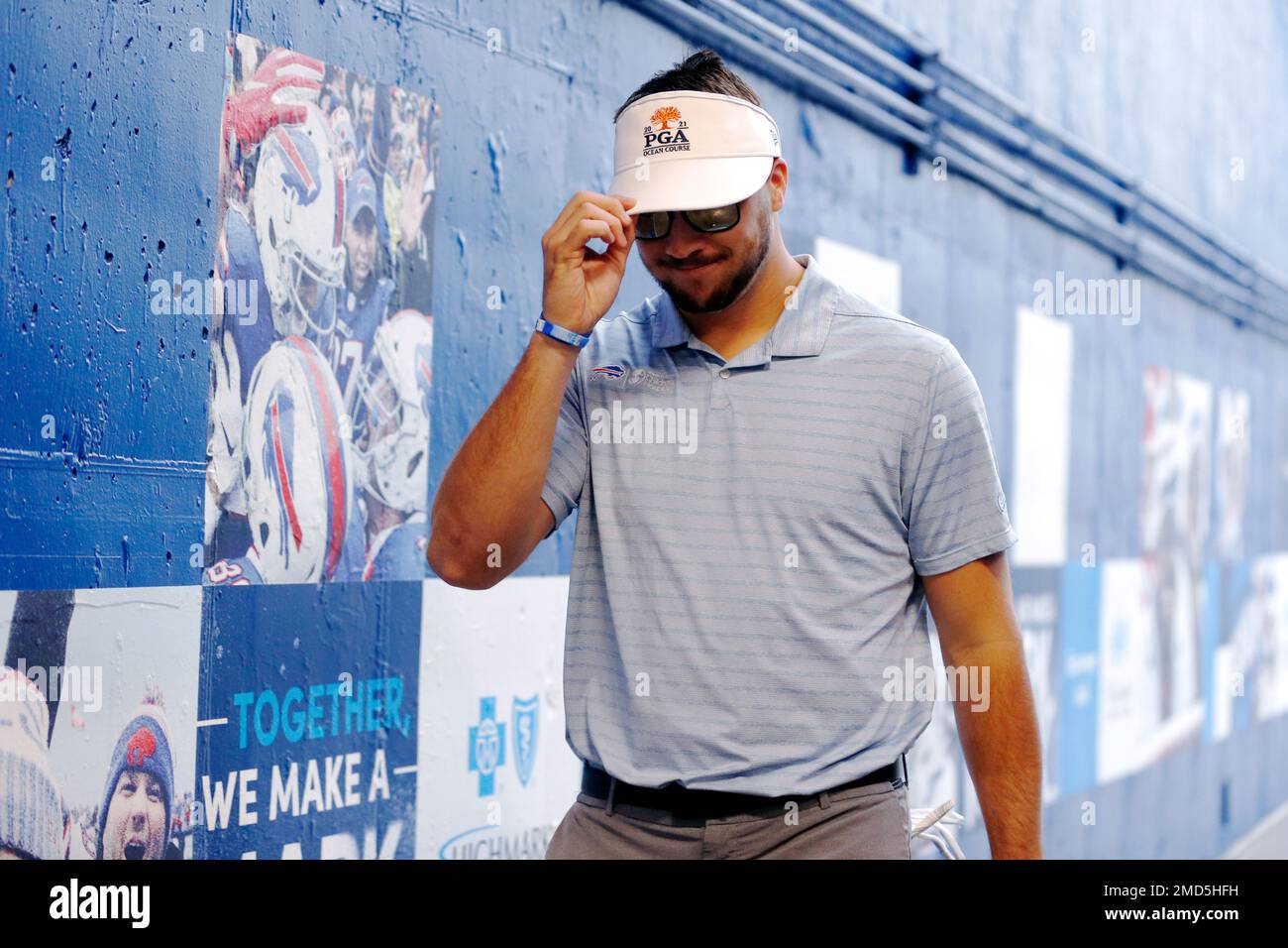 Buffalo Bills quarterback Josh Allen tips his visor as he wears golfer ...