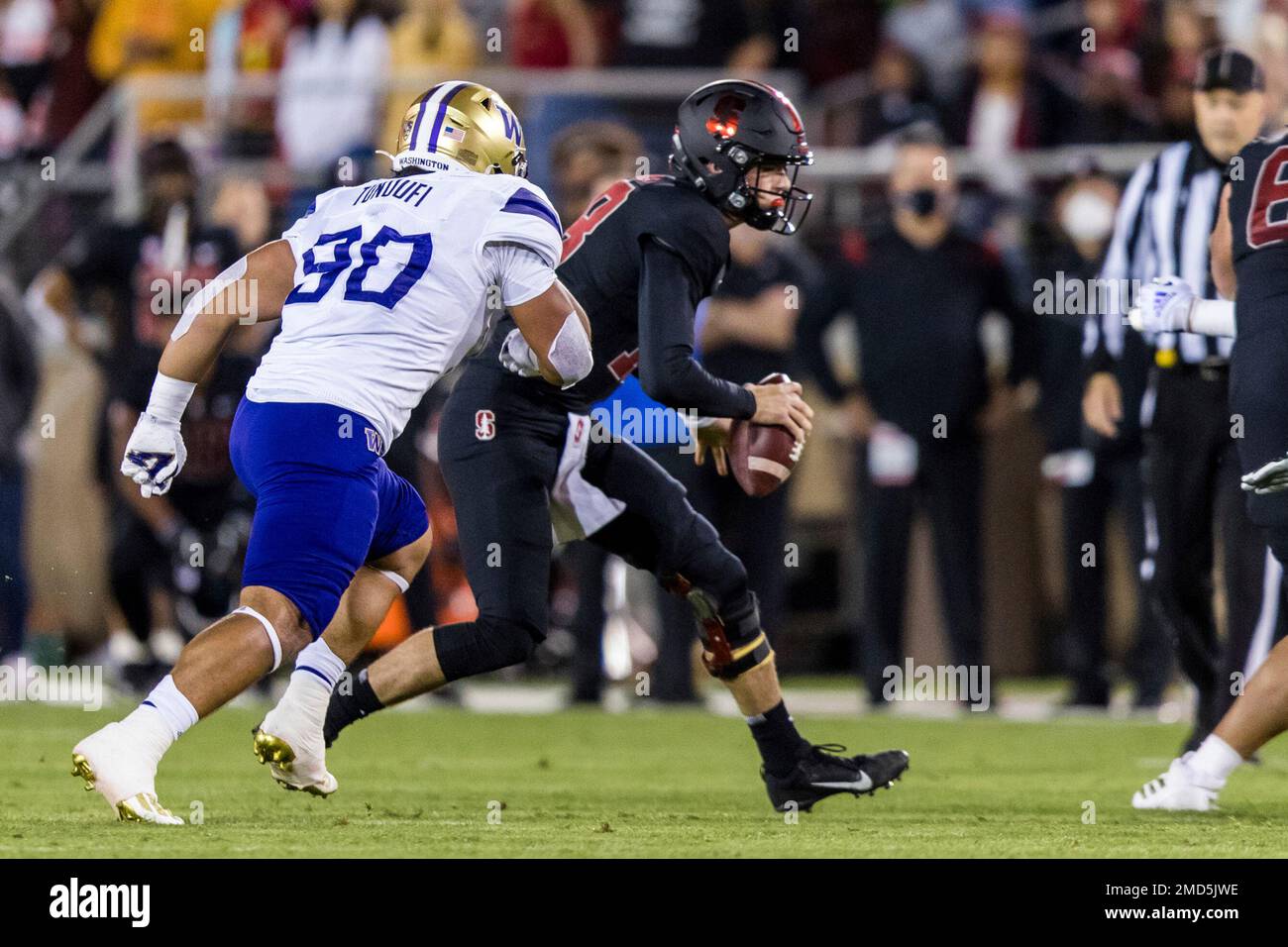 Stanford quarterback Tanner McKee, back, runs the ball as Washington ...