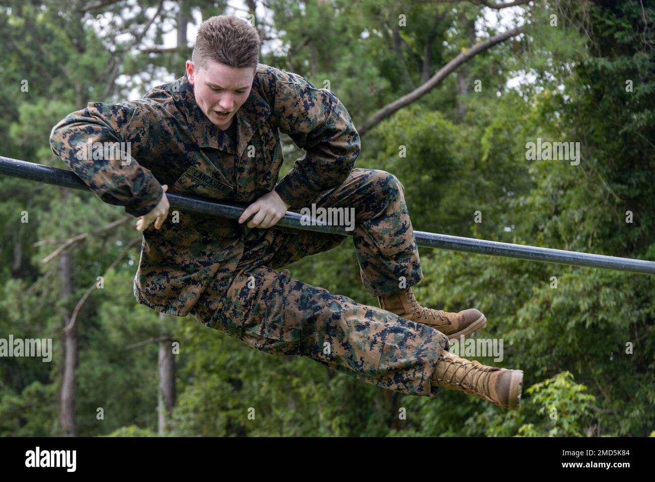 Sarah Lancaster, a midshipman at Virginia Tech, flips over a bar during ...