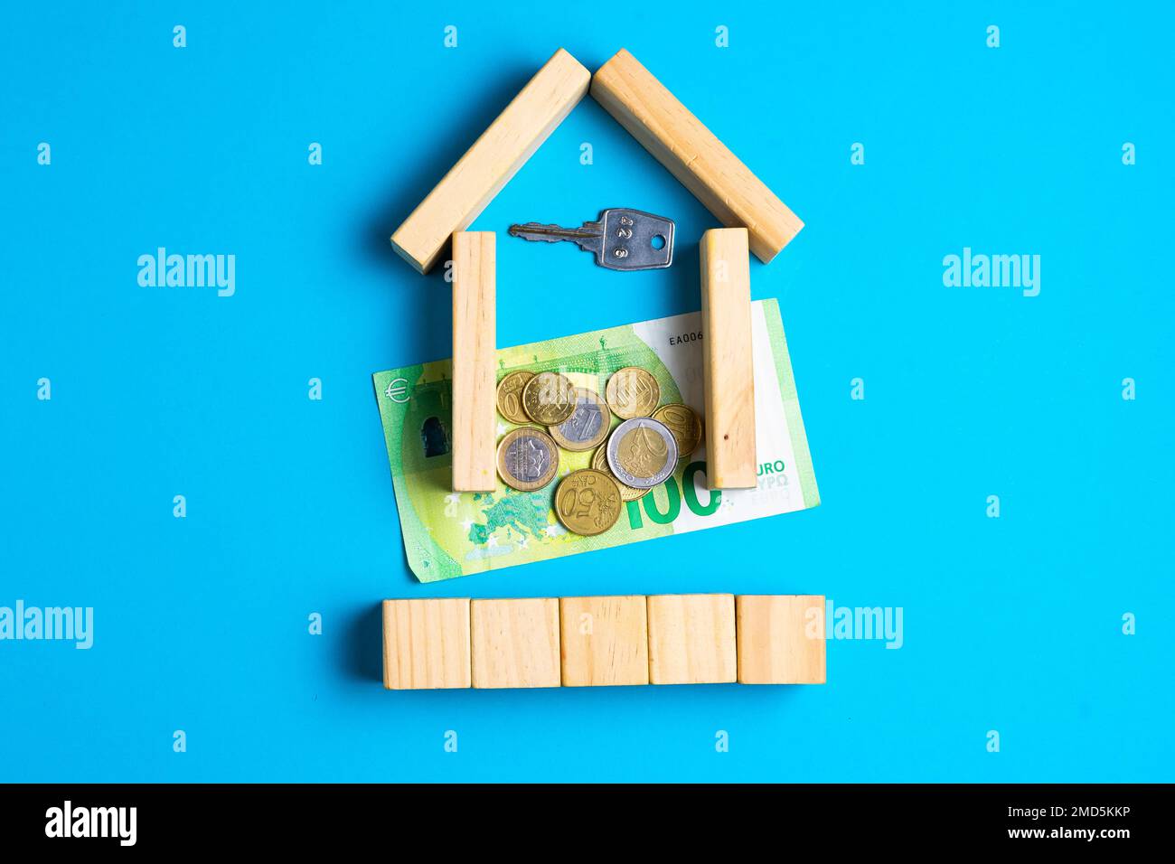Wooden toy house with keys on blue. Empty space to put text or ...