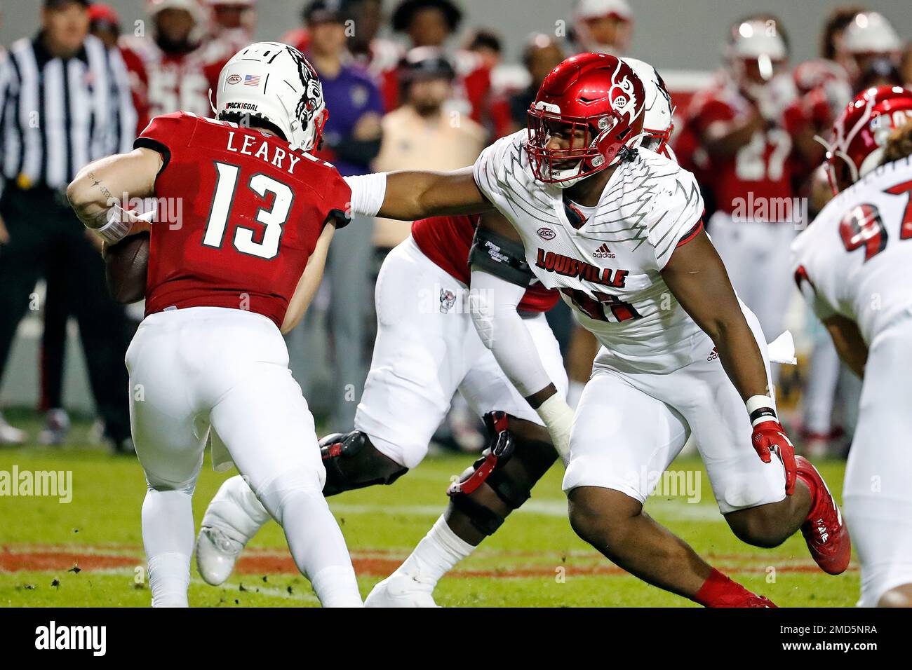 Louisville's Derek Dorsey (91) tries to capture North Carolina State ...