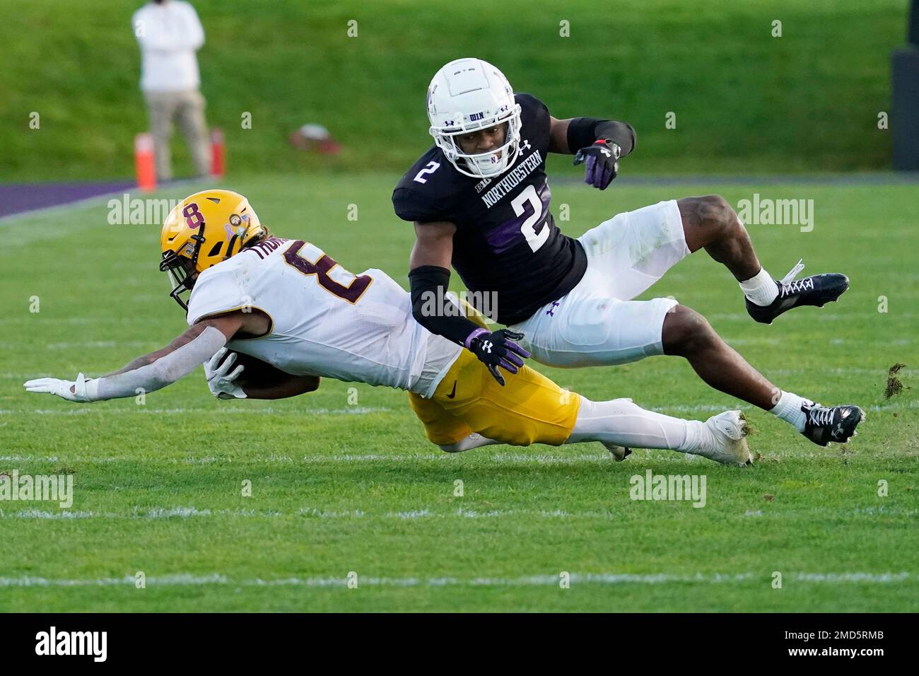 Minnesota running back Ky Thomas, left, is tackled by Northwestern ...