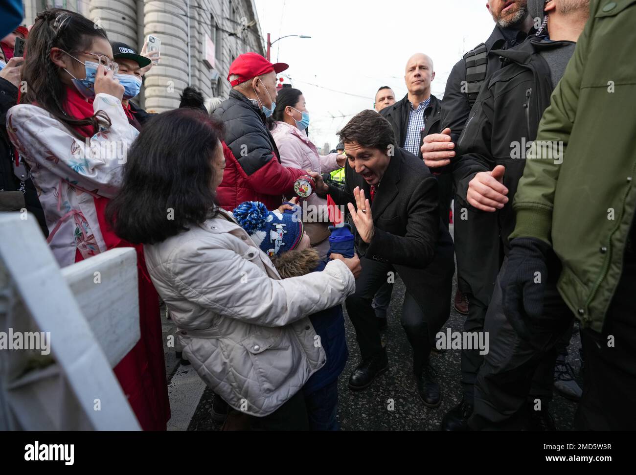 Prime Minister Justin Trudeau greets people in the crowd while marching ...