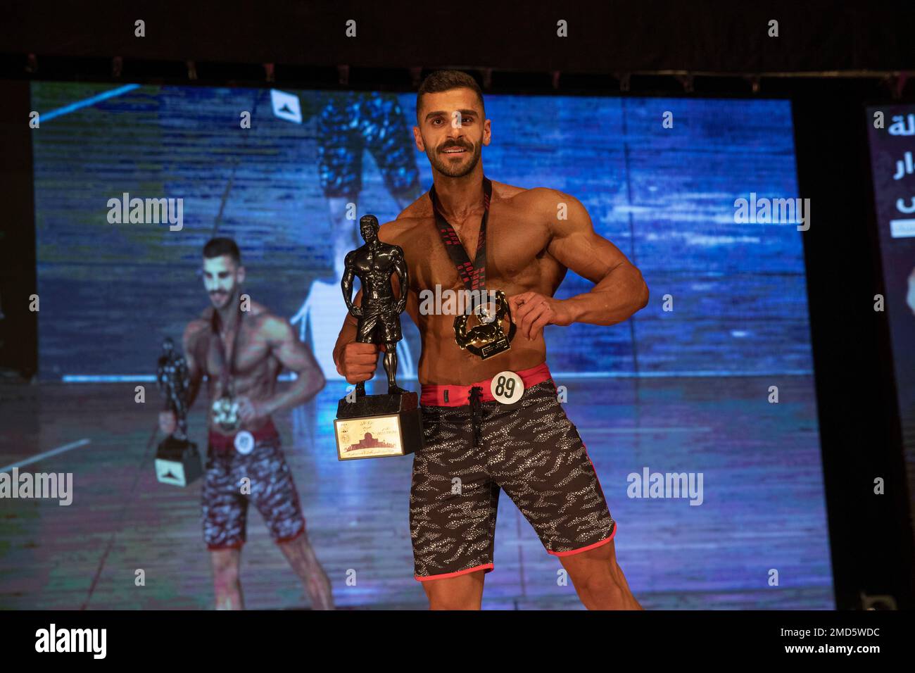 A Palestinian bodybuilder poses with his gold medal during the ...