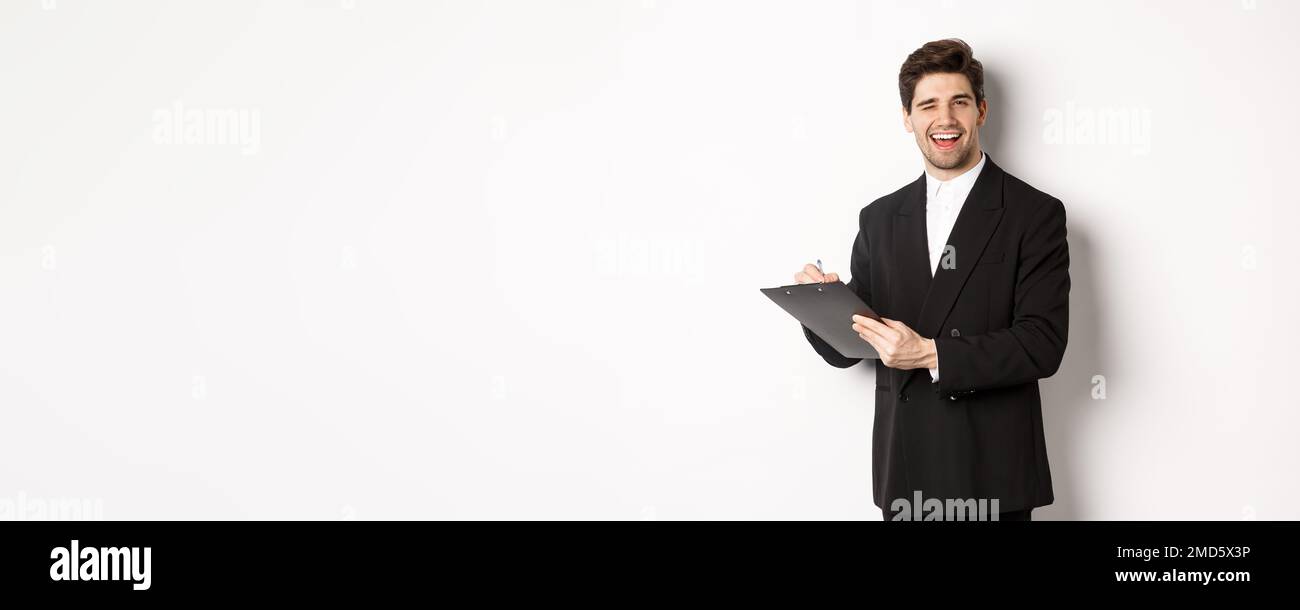 Image of handsome, successful boss in black suit, winking and smiling ...