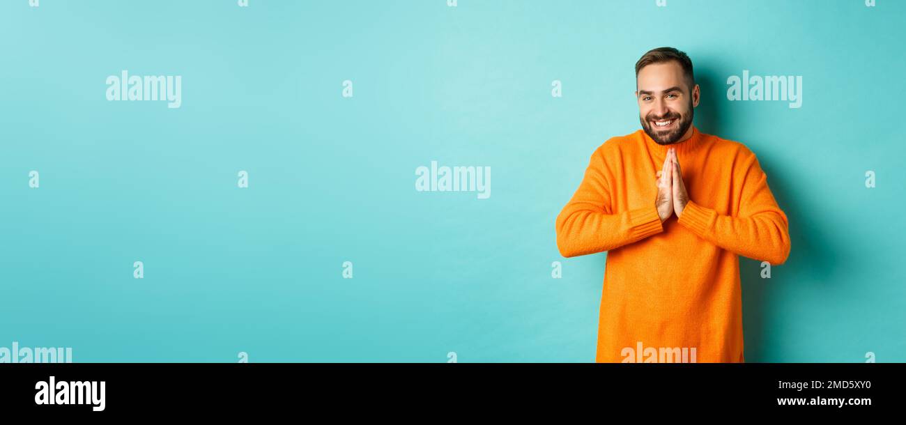 Happy man saying thank you, holding hands in pray, looking grateful and ...