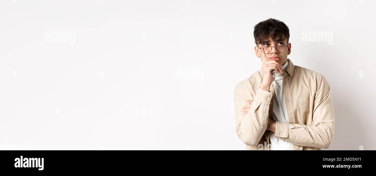 Sad and lonely young man looking at empty space with distressed face ...