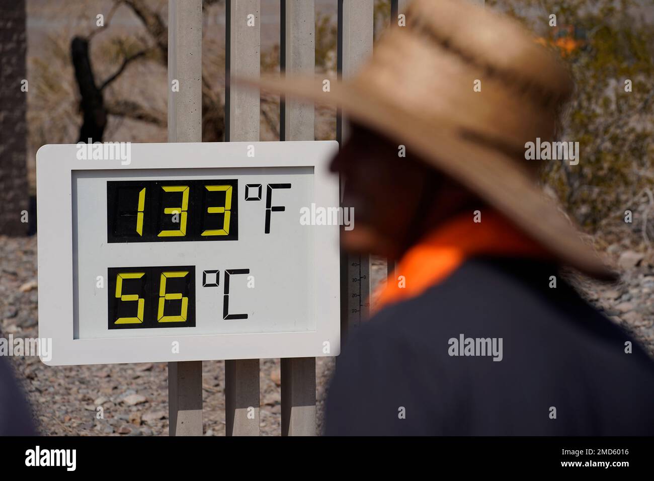 FILE - In this July 11, 2021, file photo, people visit a thermometer in ...