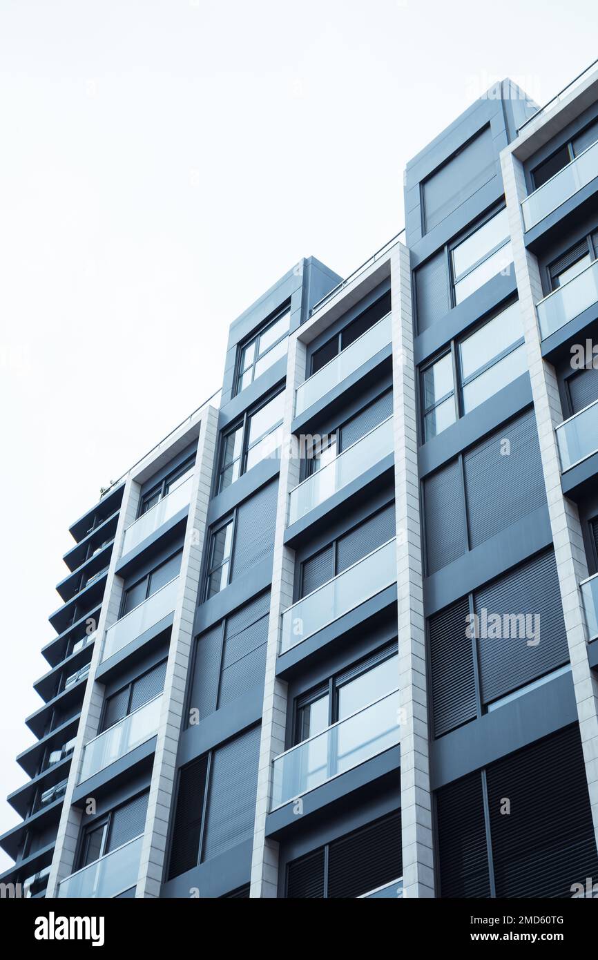 A grey blue facade of a modern multistory residential building, house ...