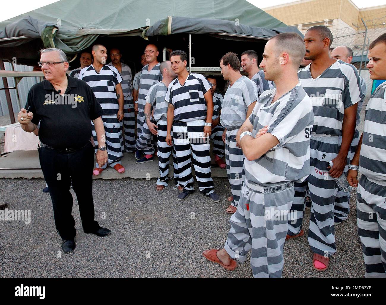 FILE- Inmates gather next to Maricopa County Sheriff Joe Arpaio as he ...