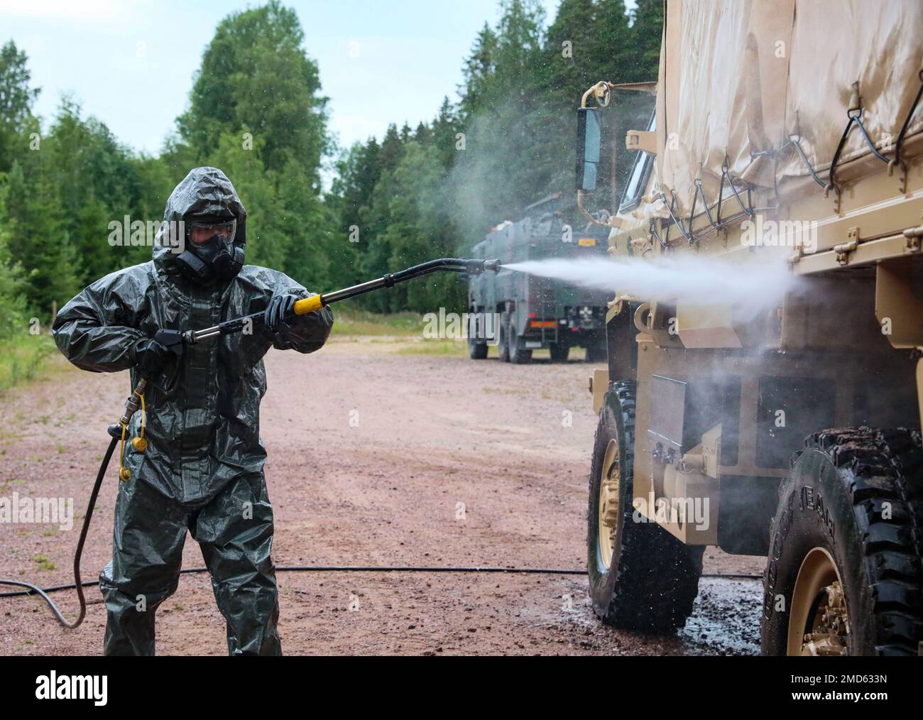 A Finnish soldier assigned to Satakunta Jaeger Battalion decontaminates ...