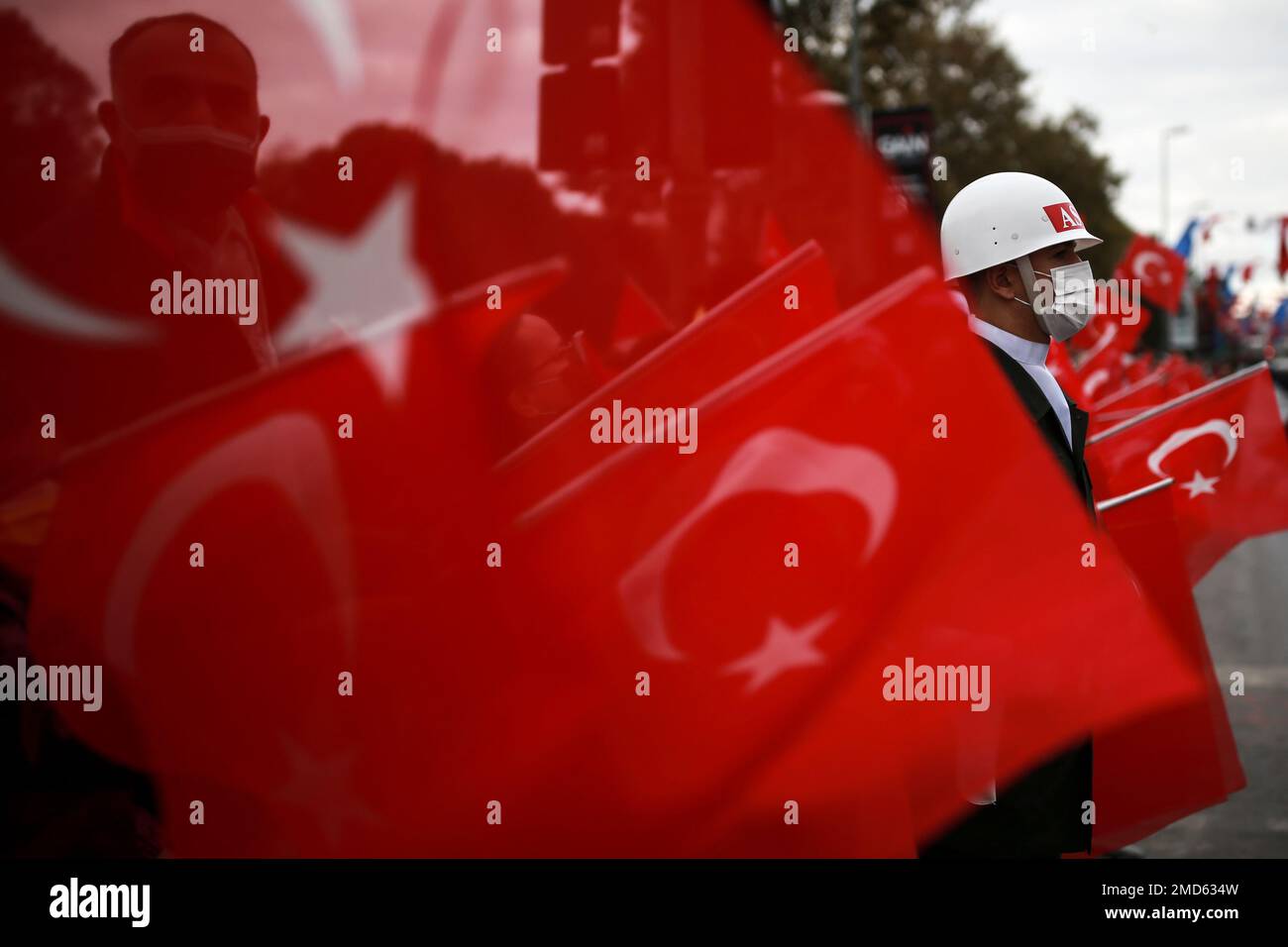People wave Turkish flags as they watch a parade during the celebration ...