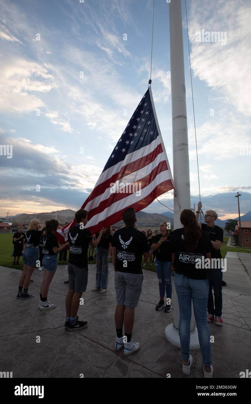 Delegates participate in a flag raising ceremony at Camp Williams, Utah ...