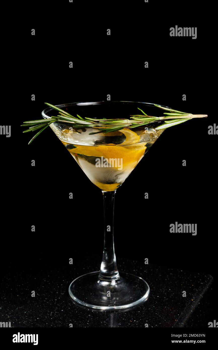 Transparent alcohol cocktail "Smoky Martini" with lemon zest and ...