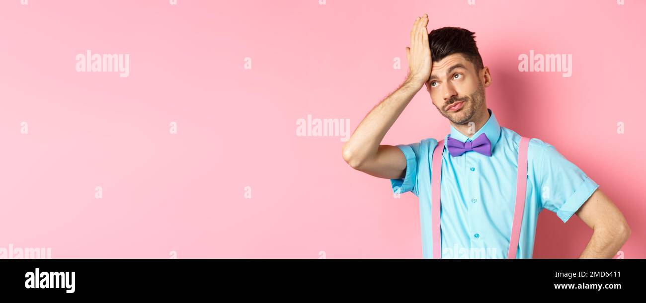 Annoyed guy with suspenders and bow-tie, facepalm with eyes rolled up ...