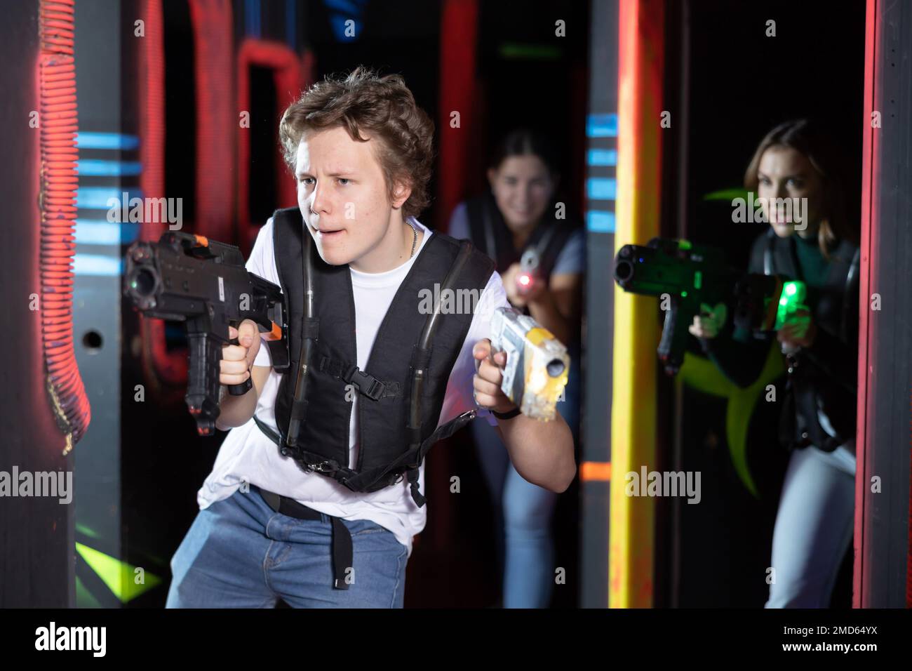 Boy running and dodging while playing lasertag Stock Photo - Alamy