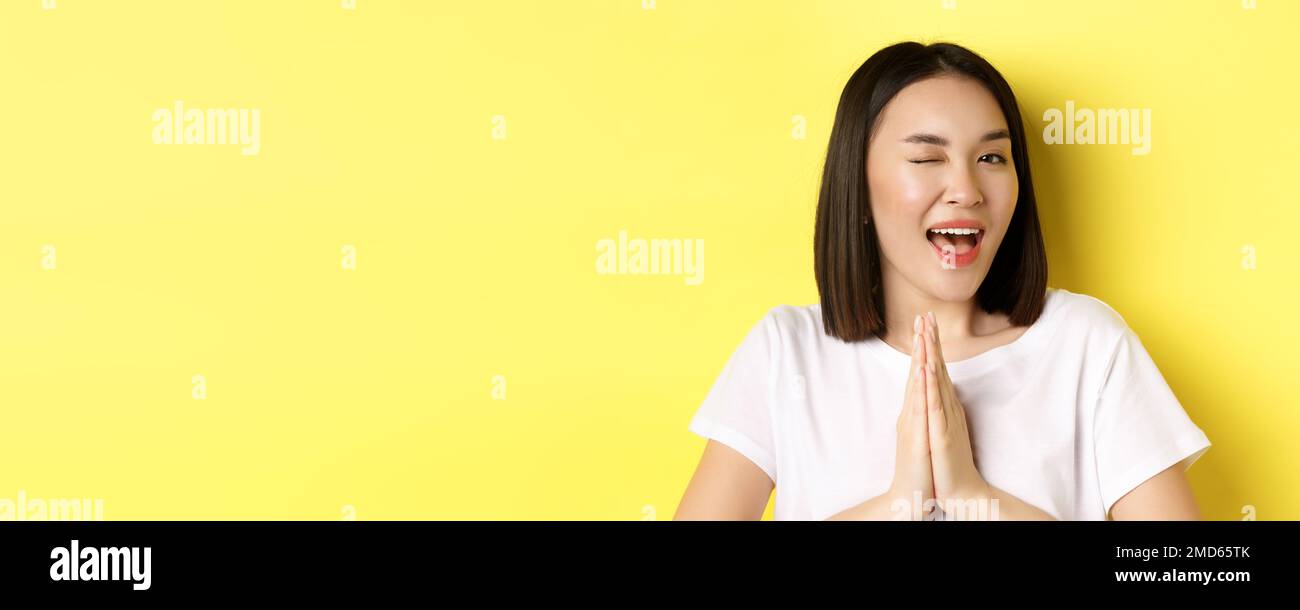 Cheerful cheeky woman yellow background hi-res stock photography and ...