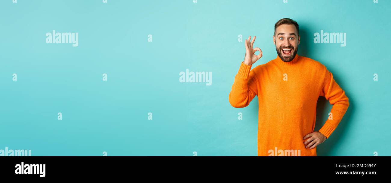 Impressed man recommending promo, showing okay sign and smiling amazed ...