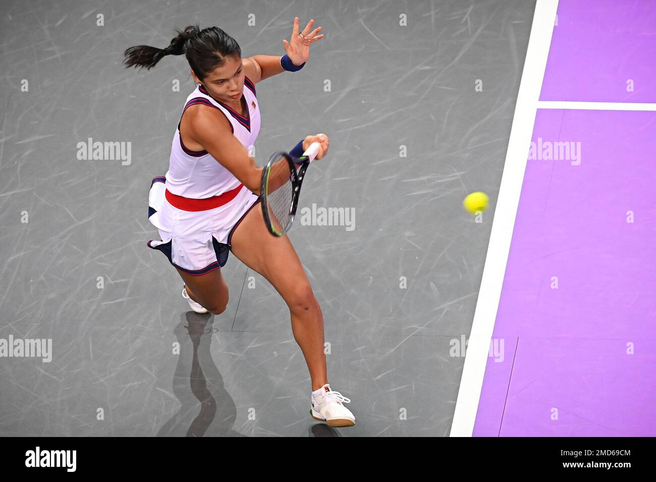 Emma Raducanu, of Britain,returns the ball to Romania's Ana Bogdan at ...