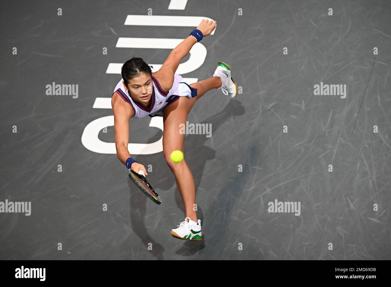 Emma Raducanu, of Britain,returns the ball to Romania's Ana Bogdan at ...