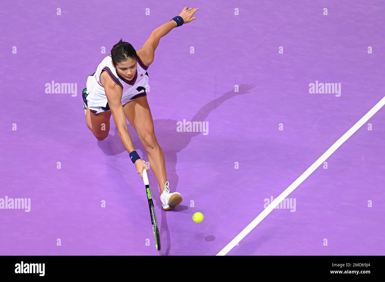Emma Raducanu, of Britain, returns the ball to Romania's Ana Bogdan at ...