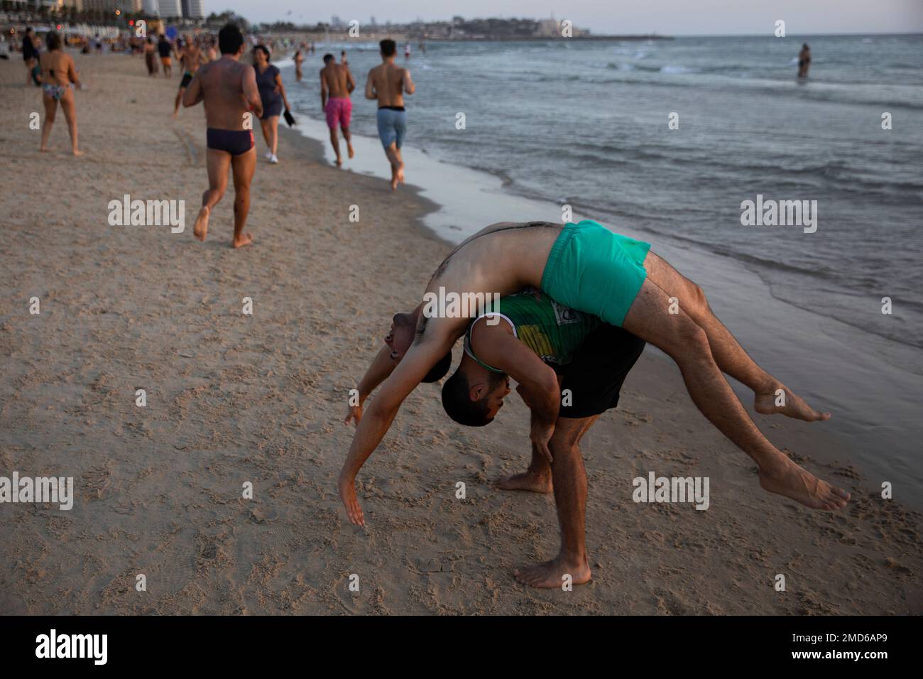 People enjoy the day the beach in Tel Aviv, Israel, Saturday, June 12 ...