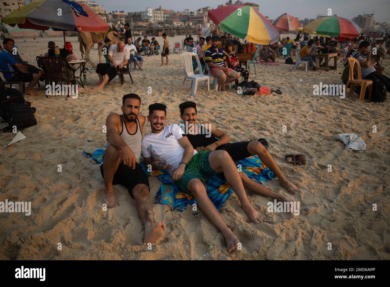 Three Palestinians pose for a photograph while enjoying a summer day ...