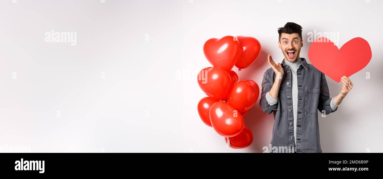 Man scream of joy and happiness, showing big red heart cutout on ...