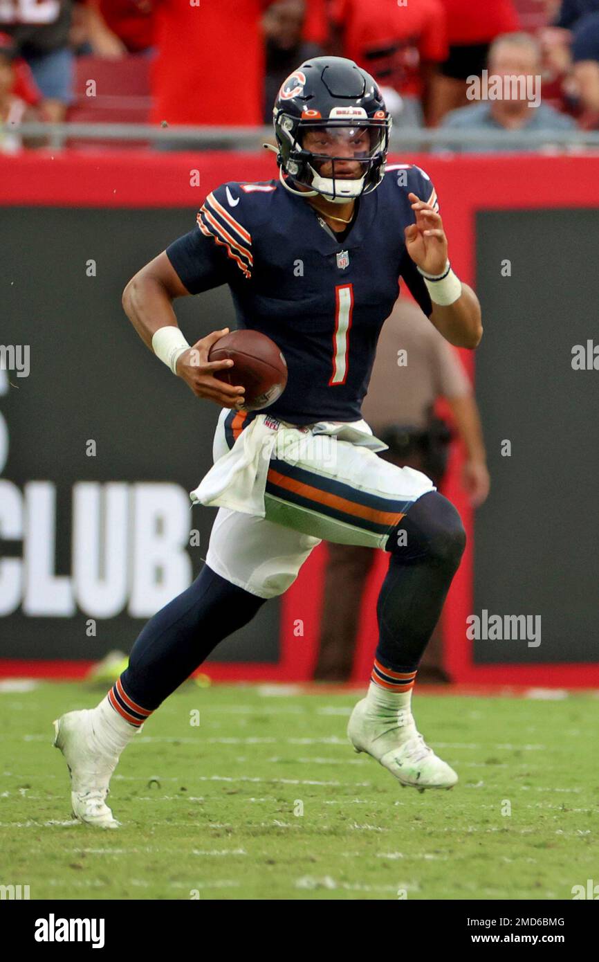 Chicago Bears quarterback Justin Fields (1) rushes during an NFL ...