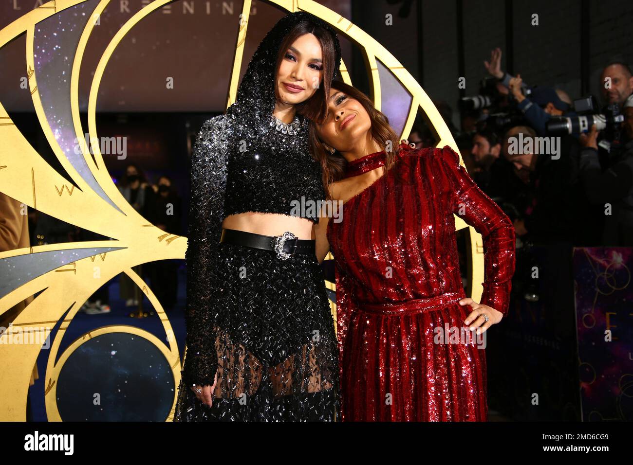 Salma Hayek, right leans on Gemma Chan as they pose for photographers ...