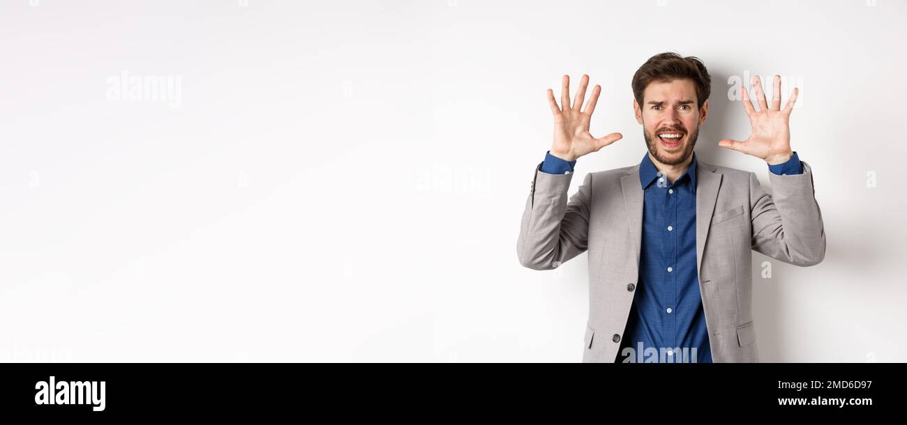 Frustrated man giving up, raising hands up in surrender and screaming ...