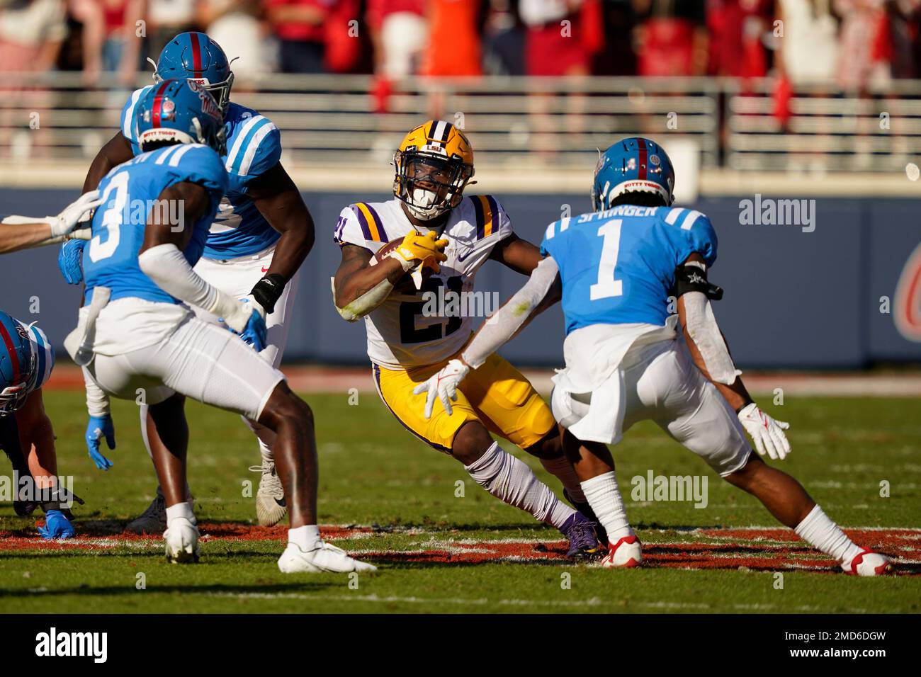 LSU running back Corey Kiner (21) attempts to dodge Mississippi ...