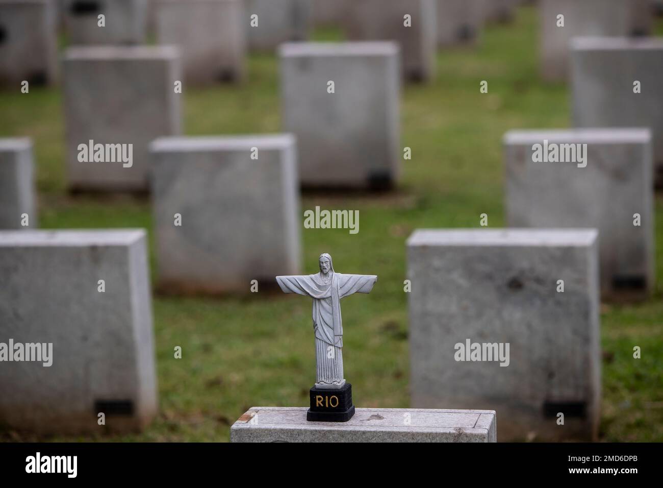 A miniature Christ the Redeemer statue adorns a tombstone at the ...