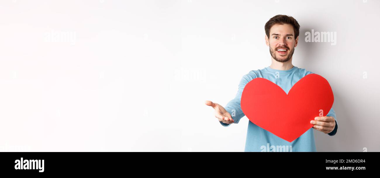 Handsome man in love making confession to you, pointing hand at camera ...