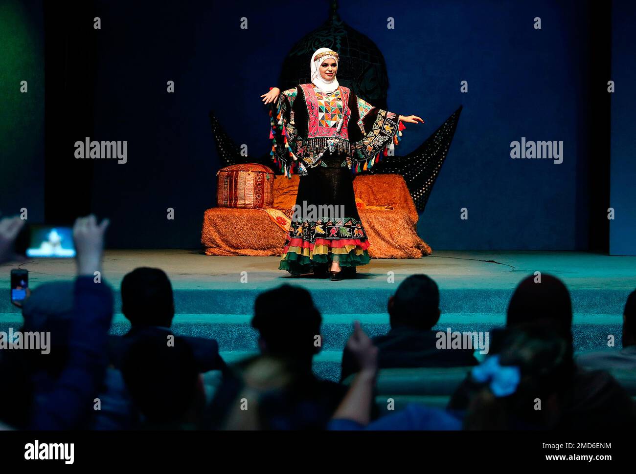 A model wearing a traditional Iraqi folk costume dances in the annual ...
