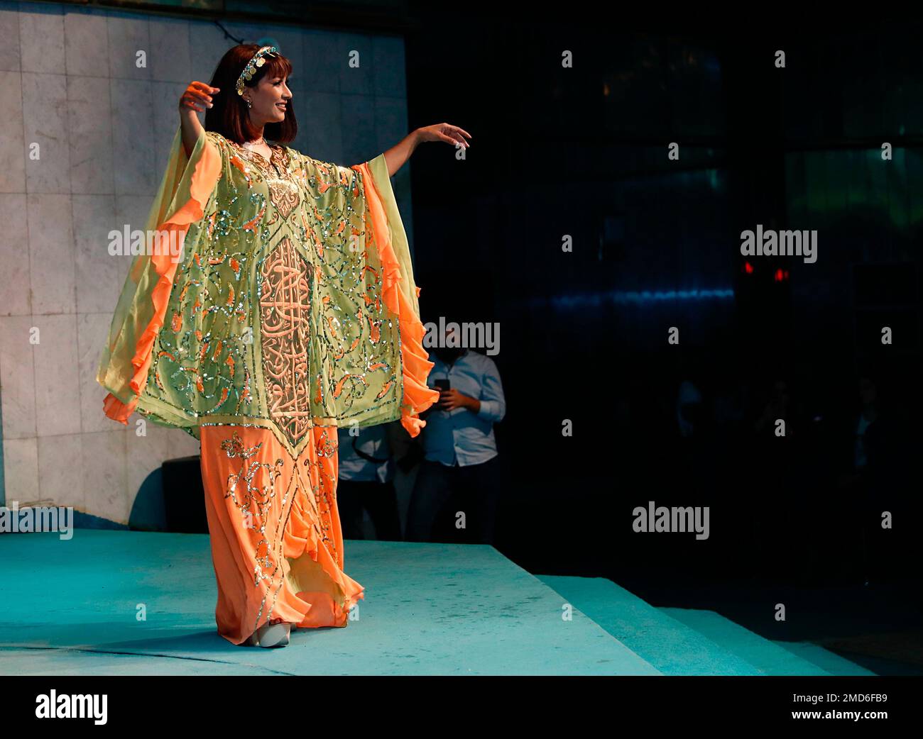 A model wearing a traditional Iraqi folk costume dances in the annual ...