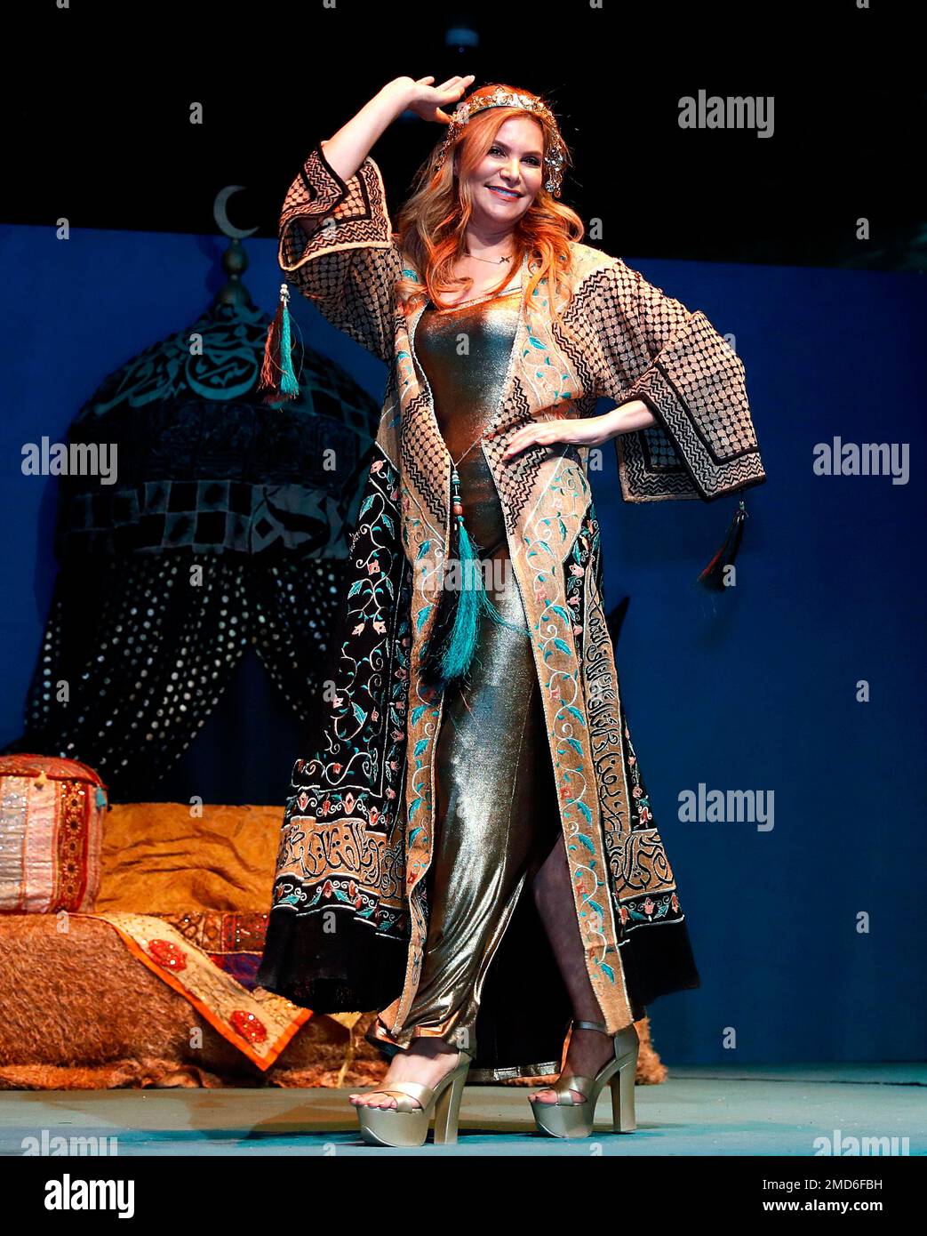 A model wearing a traditional Iraqi folk costume dances in the annual ...