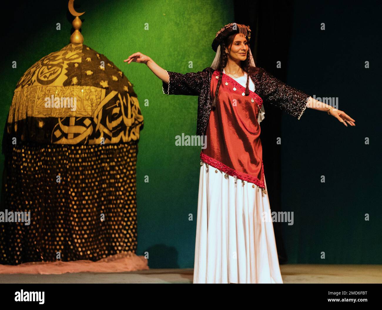 A model wearing a traditional Iraqi folk costume dances in the annual ...