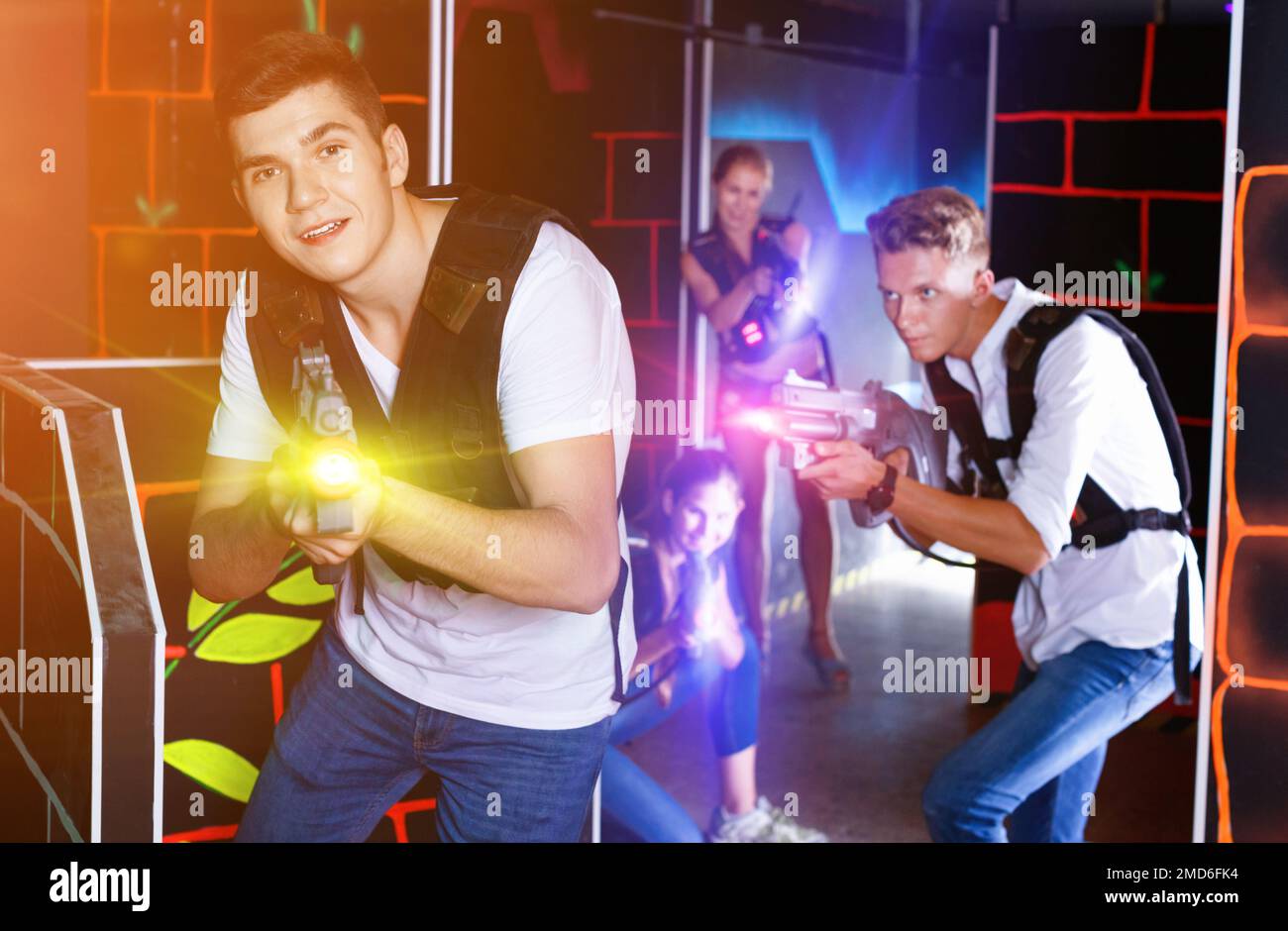 Portrait of excited guy with laser pistol playing laser tag in a Stock ...