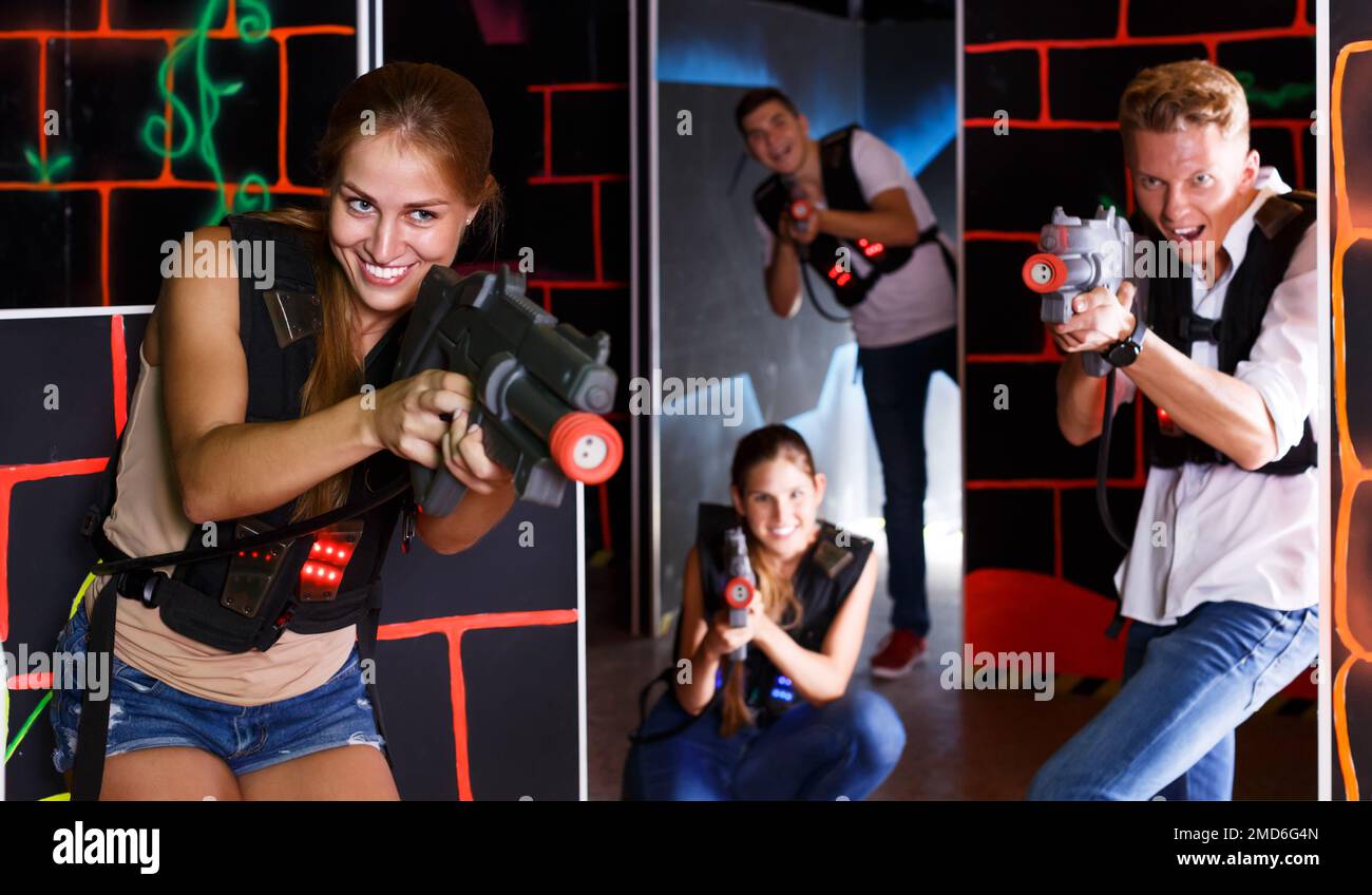 Young team playing laser tag game Stock Photo - Alamy
