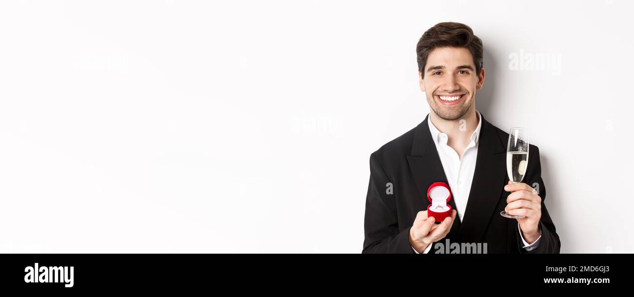 Close-up of handsome man in suit, making a proposal, giving engagement ...