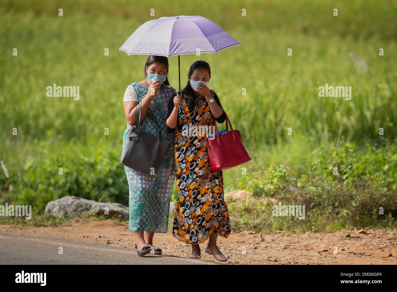 Ethnic Khasi women in traditional attire wearing face masks walk in ...