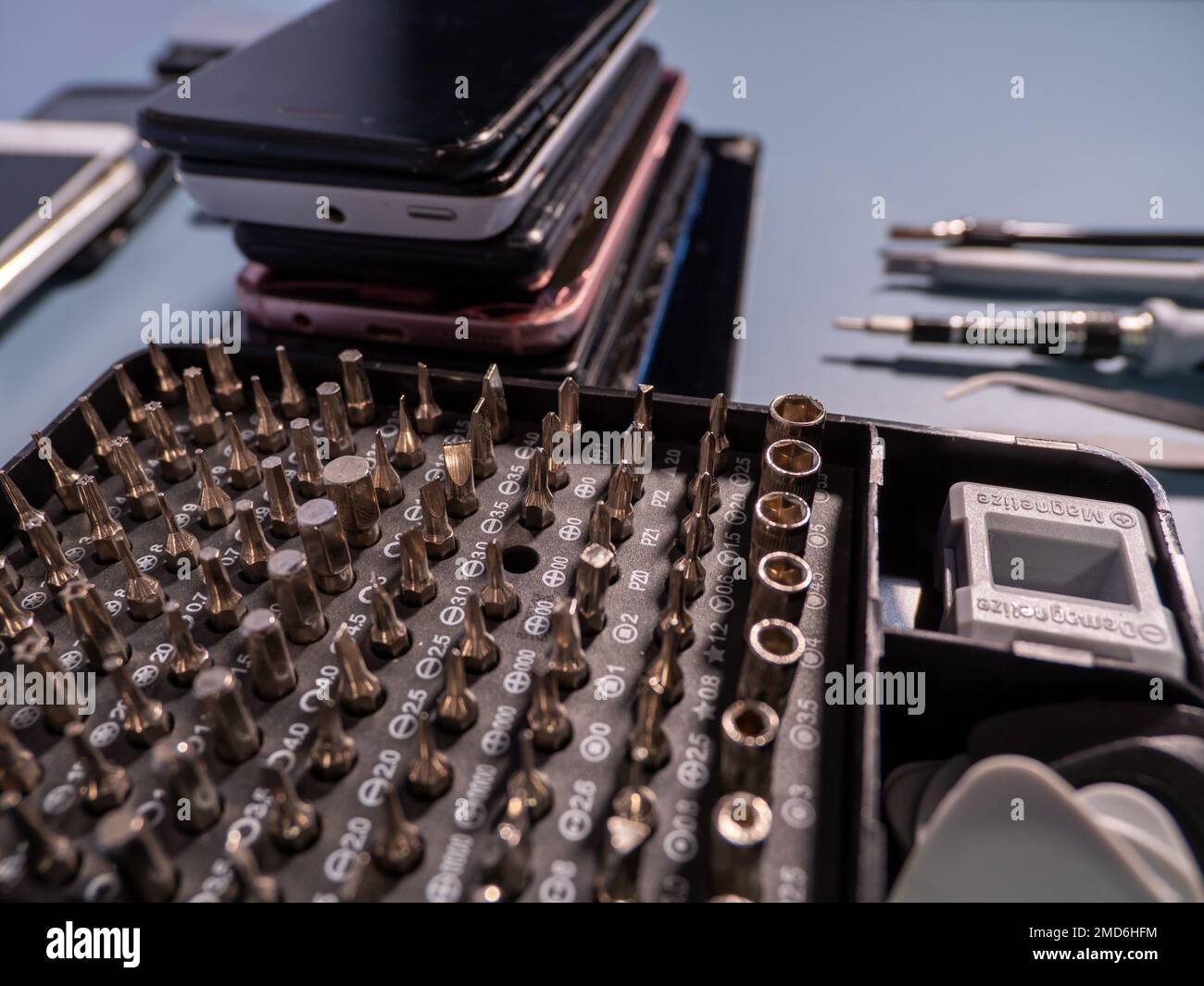 Old broken smartphone and repair tool. The concept of computer ...